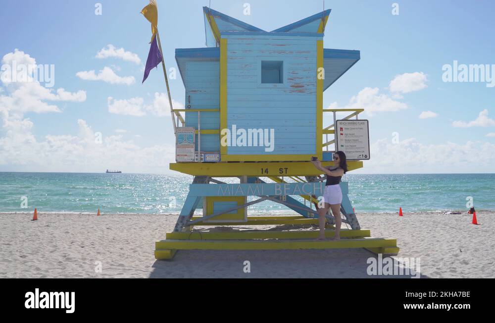 white woman taking selfie on mobile Miami Beach lifeguard station in ...