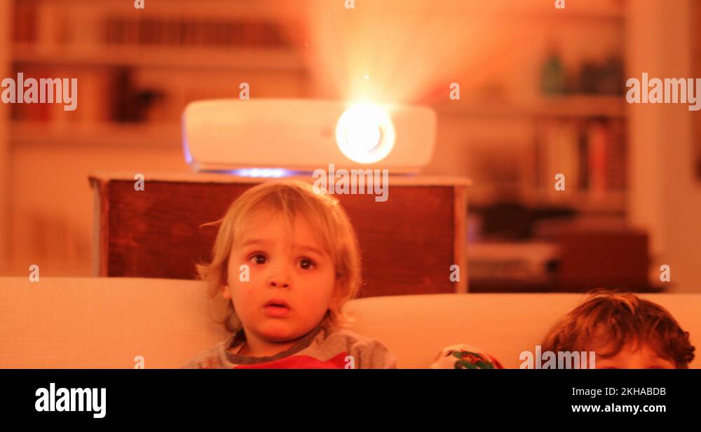 Children watching screen projected. Candid moment of kids sitting on ...