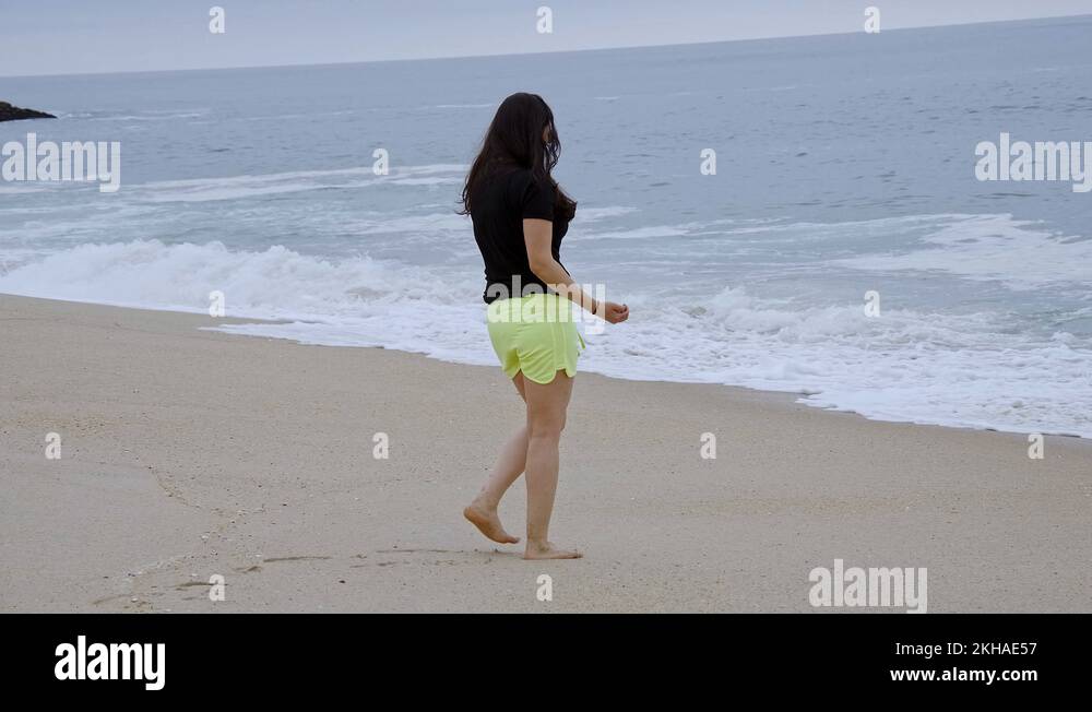 Beautiful girl has fun on the beach at the oceanfront - summer holiday ...
