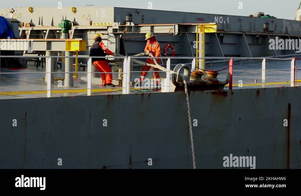 large Malaysian tanker sailors get and pull mooring rope Stock Video ...
