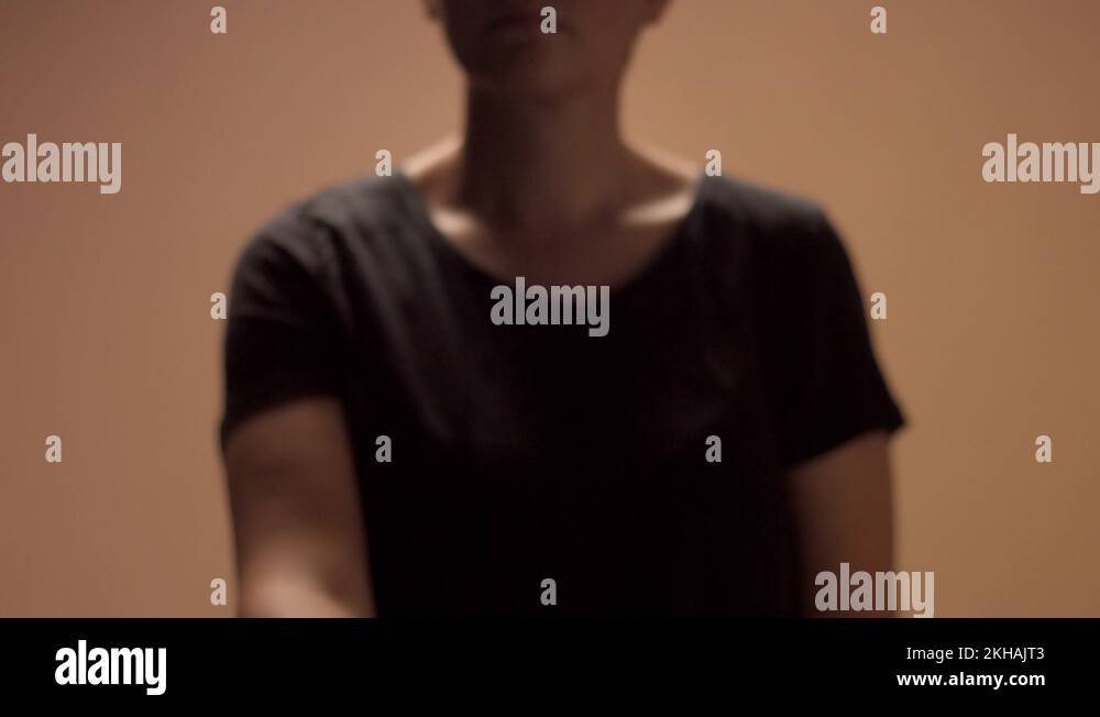 unrecognizible woman out of focus her hand towards to the camera to ...