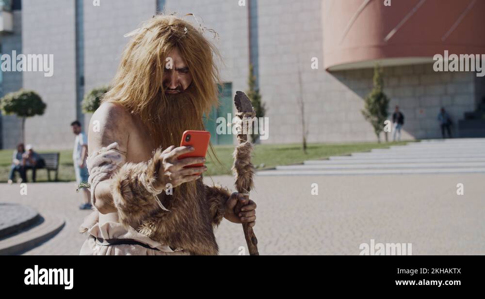 Angry neanderthal of hunter-gatherers discovering modern device use ...
