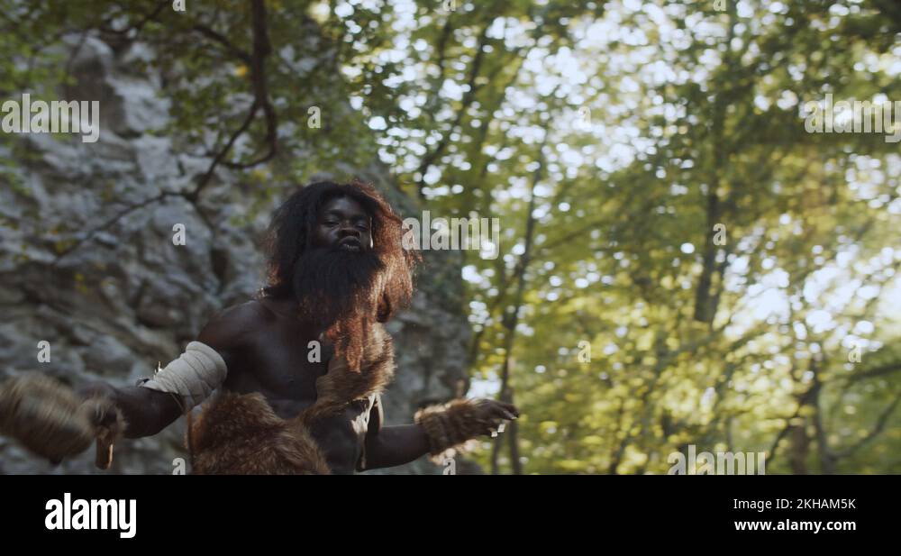 Funny dancing black caveman holding weapon neanderthals wearing animal ...