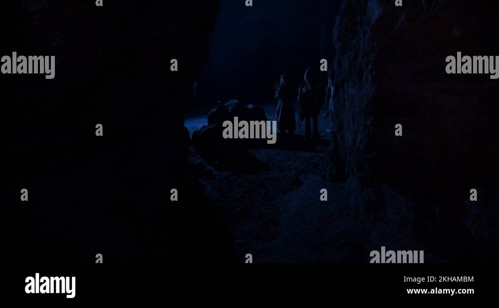 Tribe cavemen neanderthals wearing animal skin stand at dark night near ...