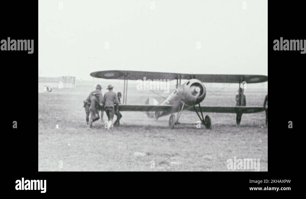 1950s: Men start airplane propeller. Airplane in sky. Bombs release ...