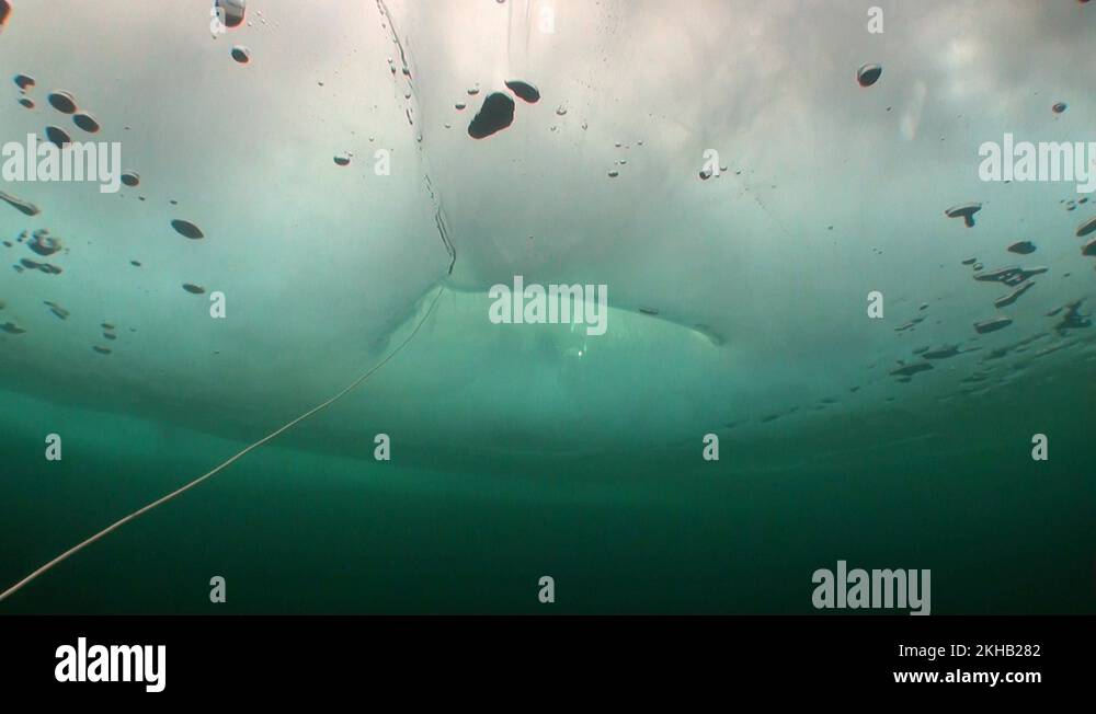 Underwater landscape of clear transparent ice under cold water of lake ...
