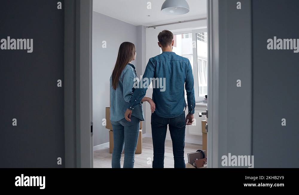 Back view of attractive couple in love which embracing and approaching ...