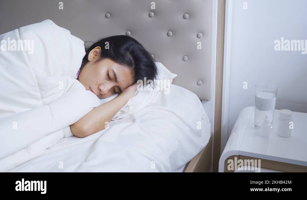Sick woman taking a rest and sleeping on bed Stock Video Footage - Alamy