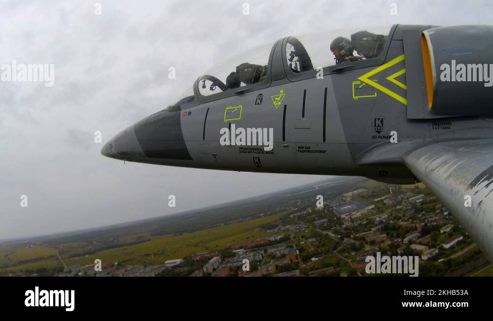 Fighter plane make double barrel roll maneuver in cloudy sky. Left wing ...