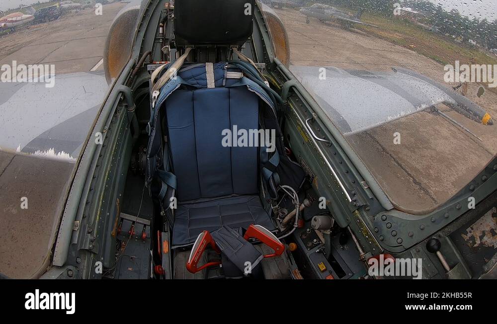 People push and move combat gray blue jet plane to parking spot at the ...