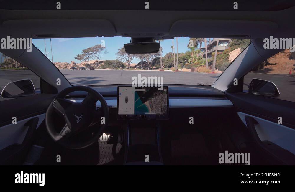 Autonomous Tesla EV car in full self driving autopilot mode Stock Video ...