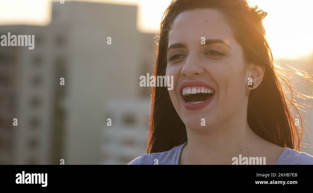 Happy hispanic latina girl smiling and laughing during golden hour ...