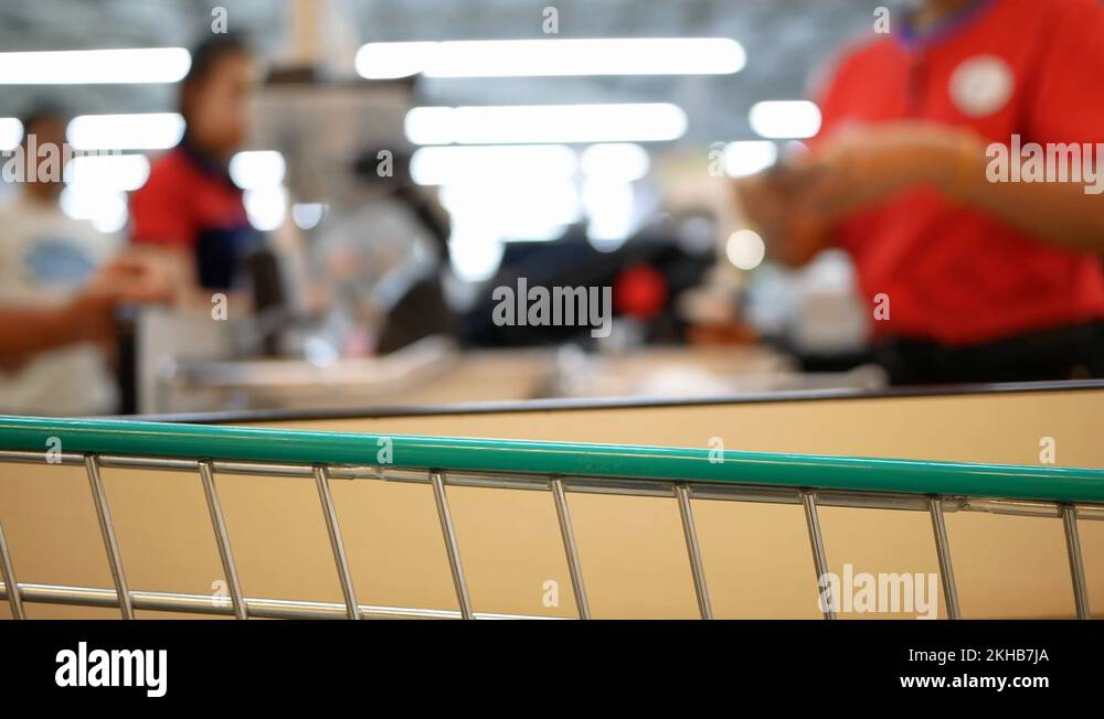 Little child girl with her family at a supermarket cashier before come ...