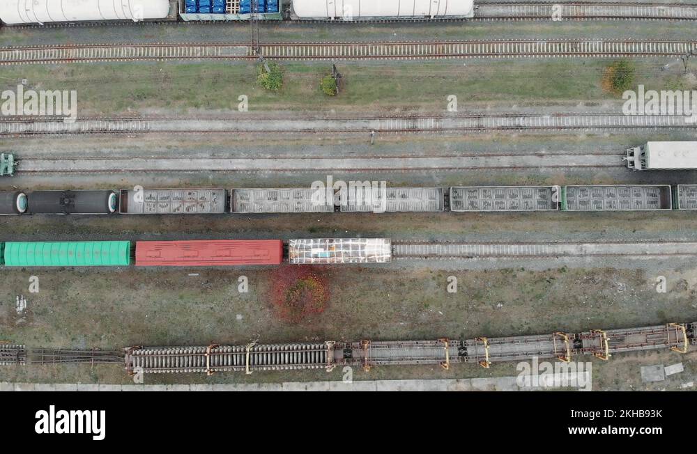 Drone top view of cargo freight trains and railway tracks in industrial ...