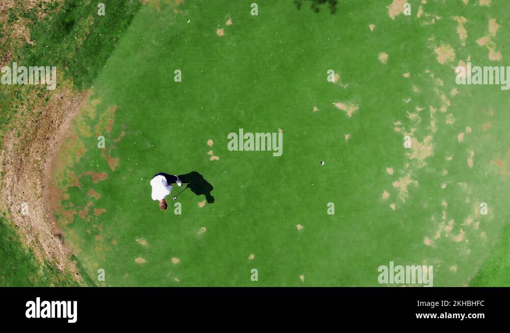 The golf ball is rolling past the hole after the strike. Fail, failure ...