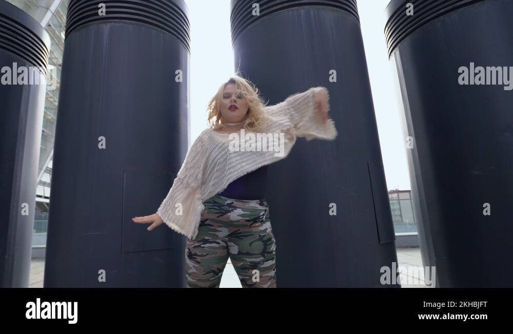 Sexy plus size woman dancing outdoors, challenging unrealistic beauty ...