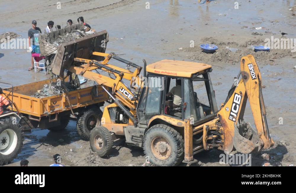 JCB cleaning up the beach with plastic bags full of garbage Stock Video ...