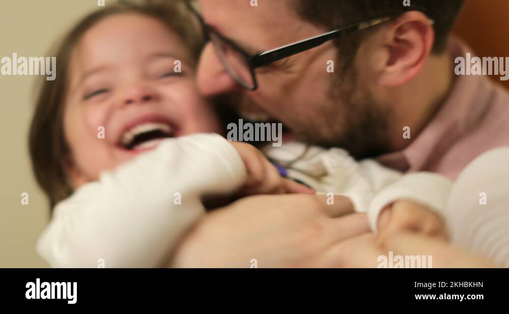Father holding little girl in his arms making her laugh Stock Video ...