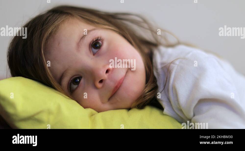 Little girl watching TV while nose picking. Child nose picks Stock ...