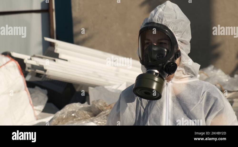 Scientist in garbage dump, gas mask, filter, work, determine level of ...