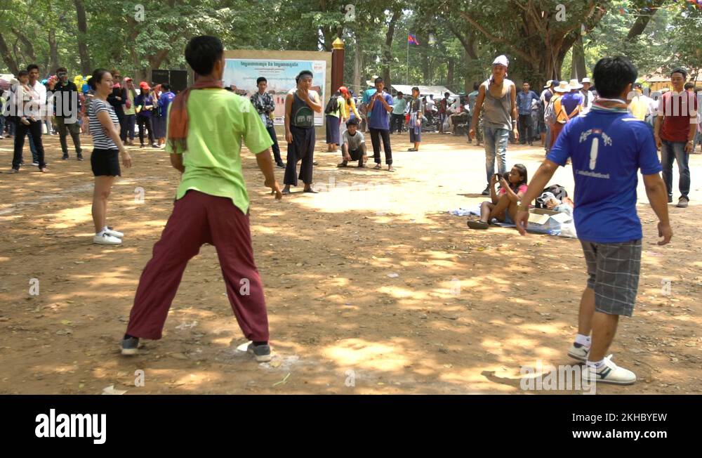 Slow motion double kick to a shuttlecock during a jianzi game in Siem ...