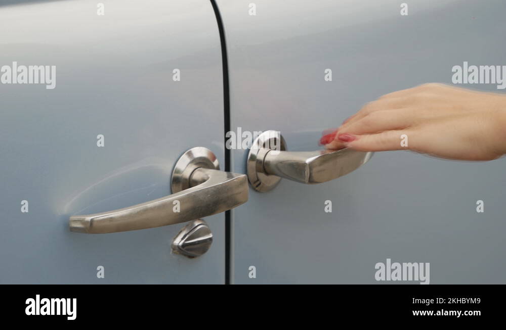 female hand hesitantly opens and closes the door of a vintage car Stock ...
