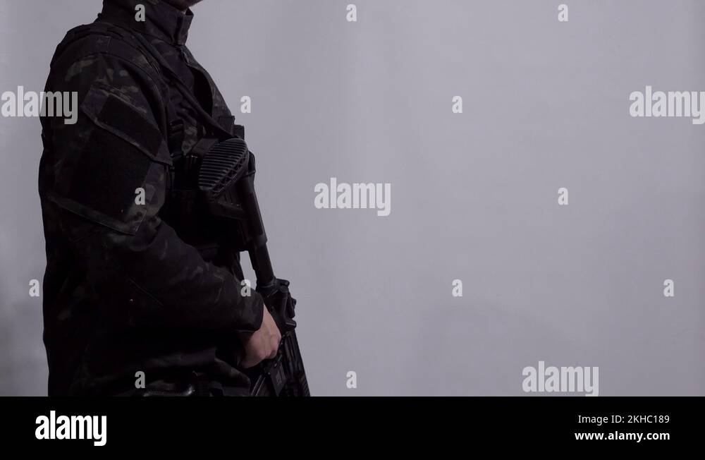 A man aiming with submachine gun and then aiming with a pistol Stock ...