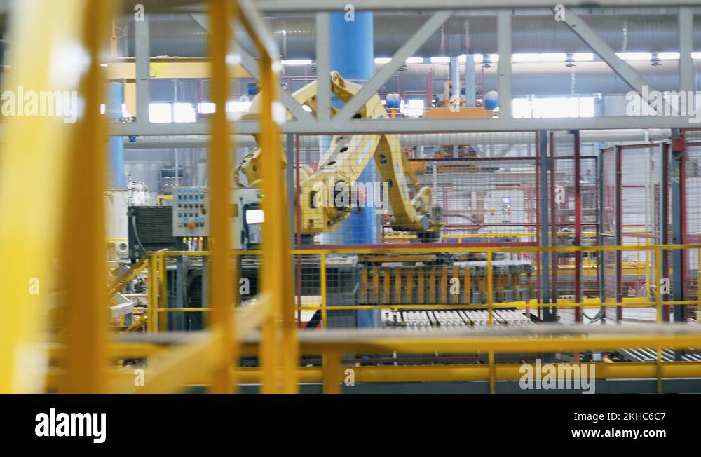 Robotic machine moving bricks on a line at a modern industrial factory ...