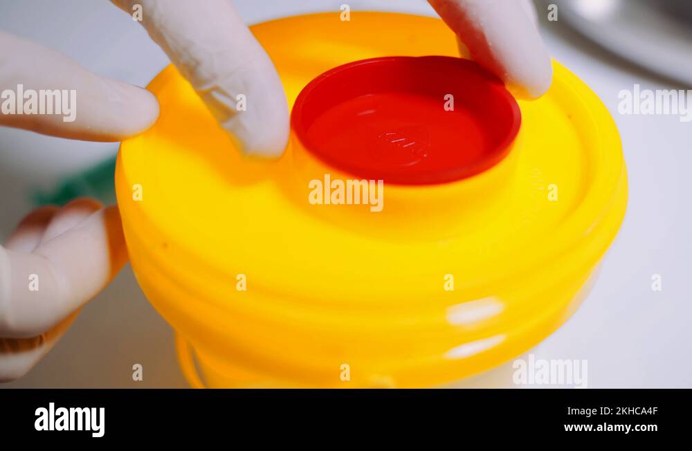 Container for disposing of used syringes. A healthcare professional ...