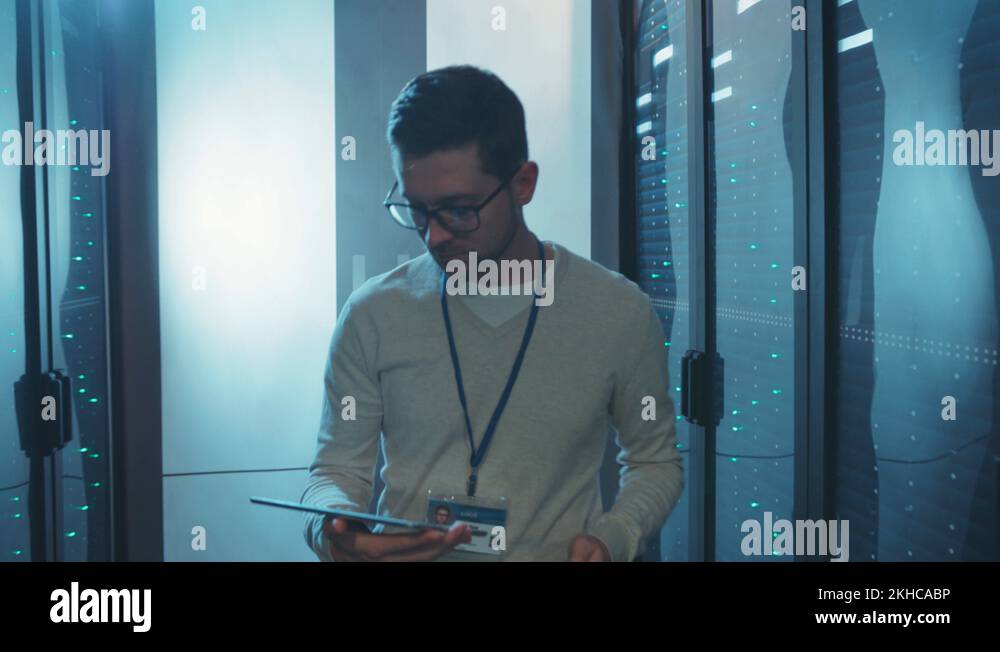 Data center IT administrator opening rack server cabinet checking ...