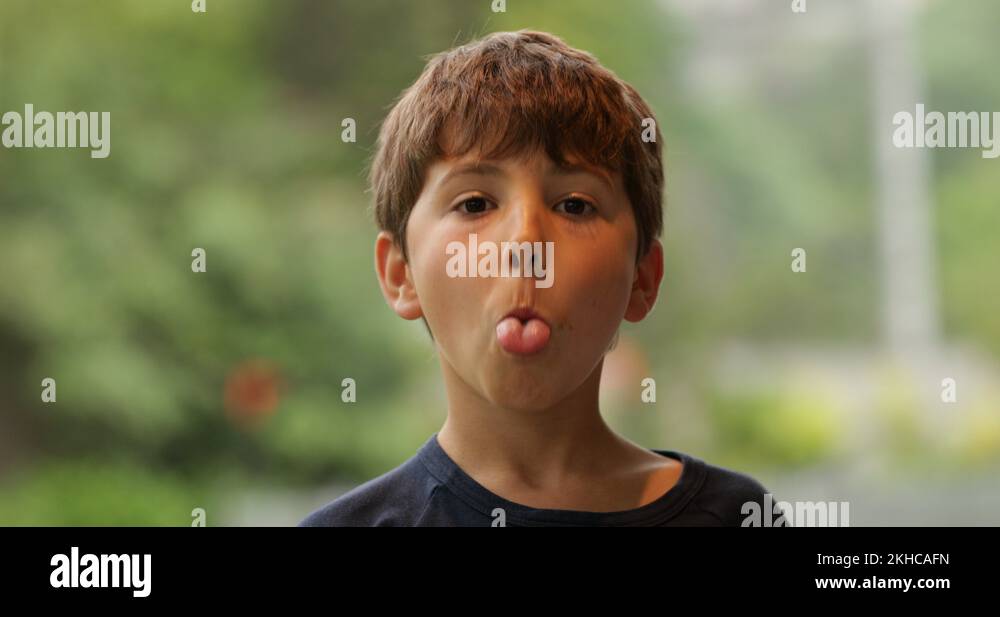 Young child sticking tongue out misbehaving in 4k. Disobedient kid ...