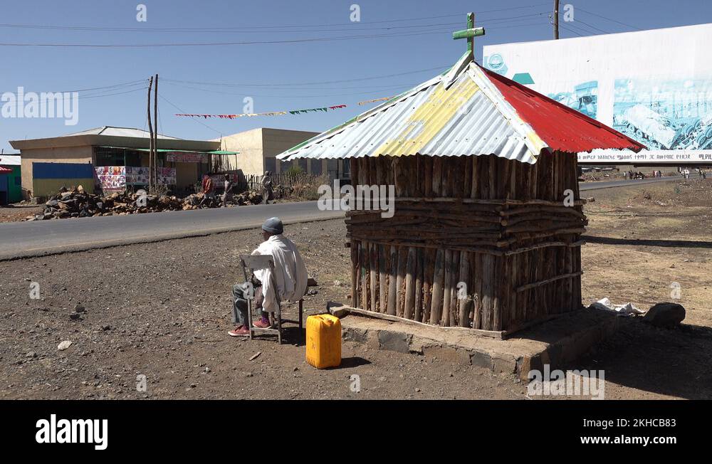 Priest at small wooden monastery on roadside small village community in ...