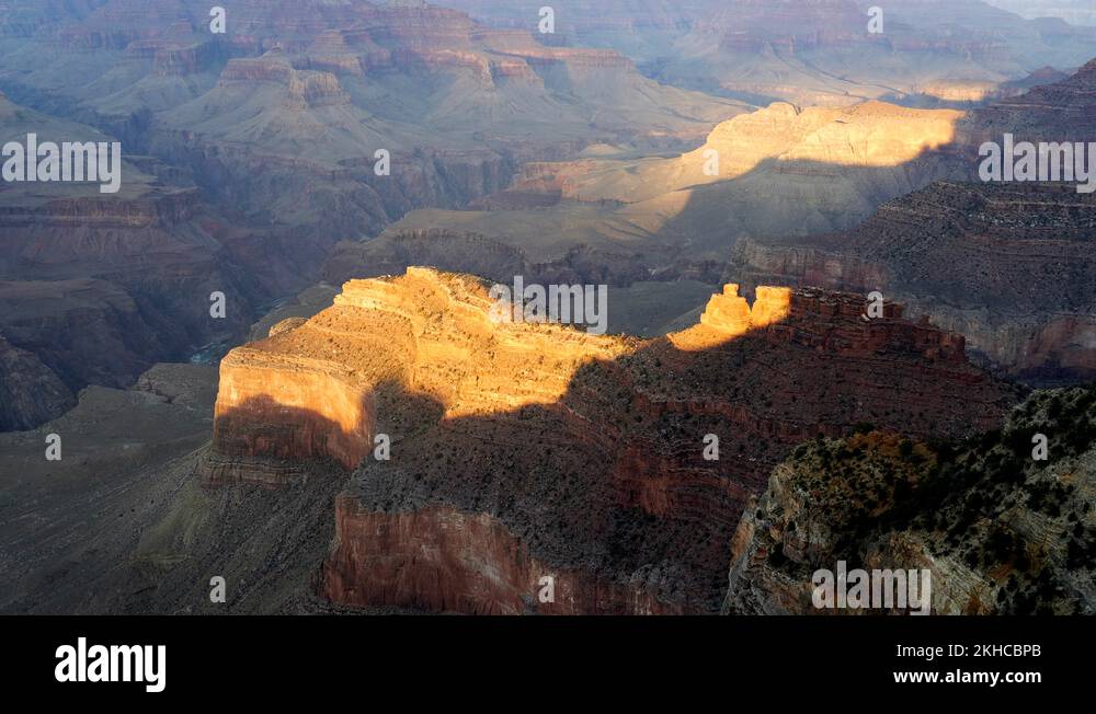 zoom in on sunlit canyon walls at the grand canyon from hopi point ...
