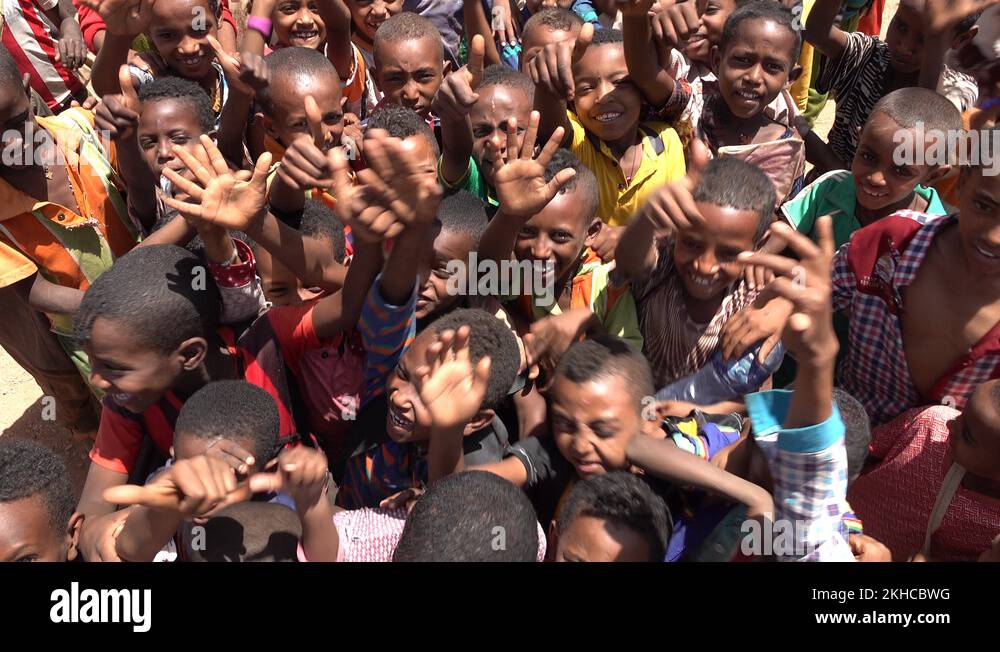Crowds of African school kids laughing smiling, education poverty ...