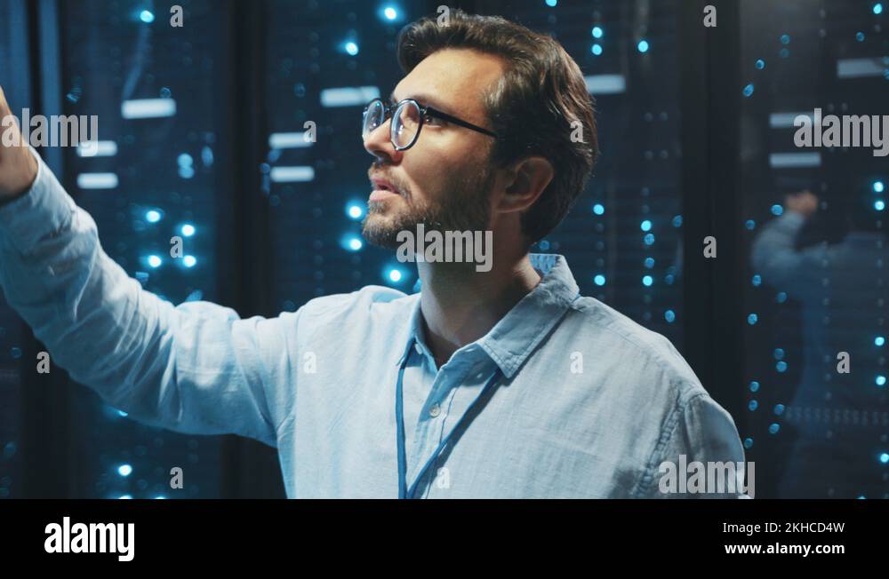 IT technician in data center digital server room controlling work of ...