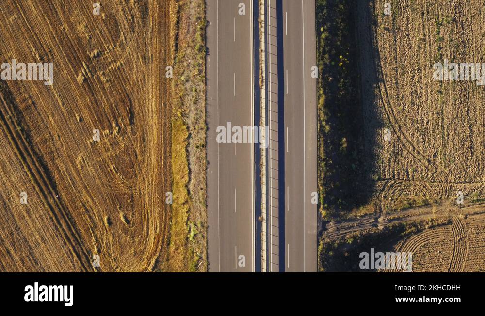A few some car driving along the two sided highway in rural landscape ...