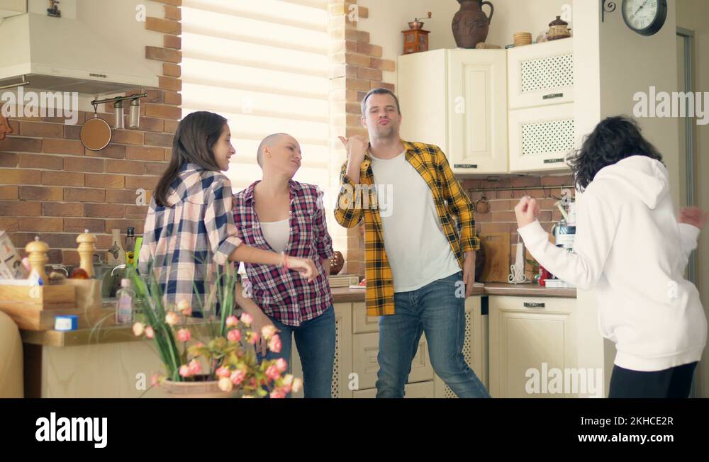 a bald woman spends time with her family. husband, wife, boy and girl ...