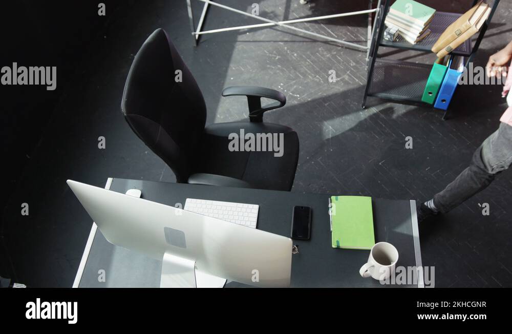 Downward view black business manager taking his seat starting a new ...