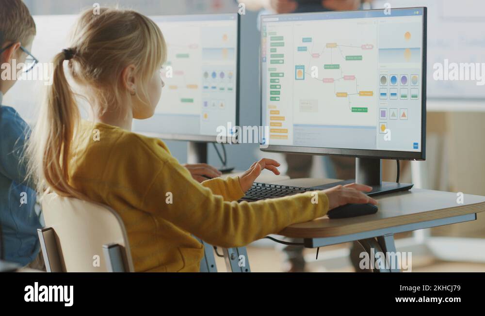 Elementary School Computer Science Classroom: Cute Little Girl Uses PC ...