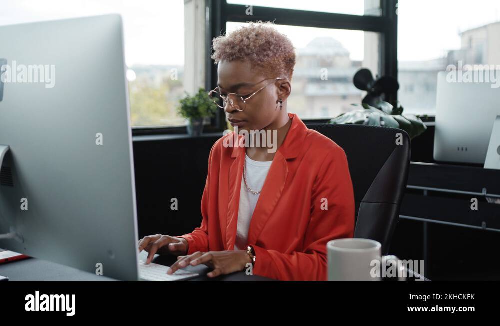 Beautiful young black woman business person typing keyboard working on ...