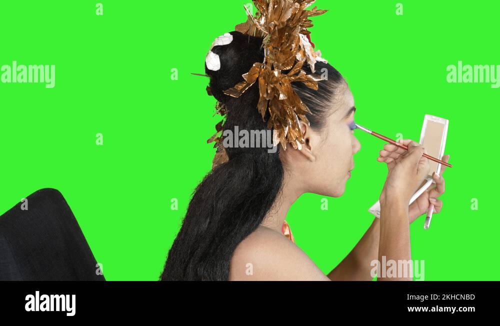 Balinese dancer coloring her eyelids in studio Stock Video Footage - Alamy