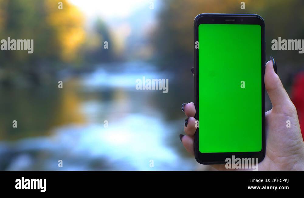 Smartphone at Nature 4k technologies concept: mobile phone with green ...