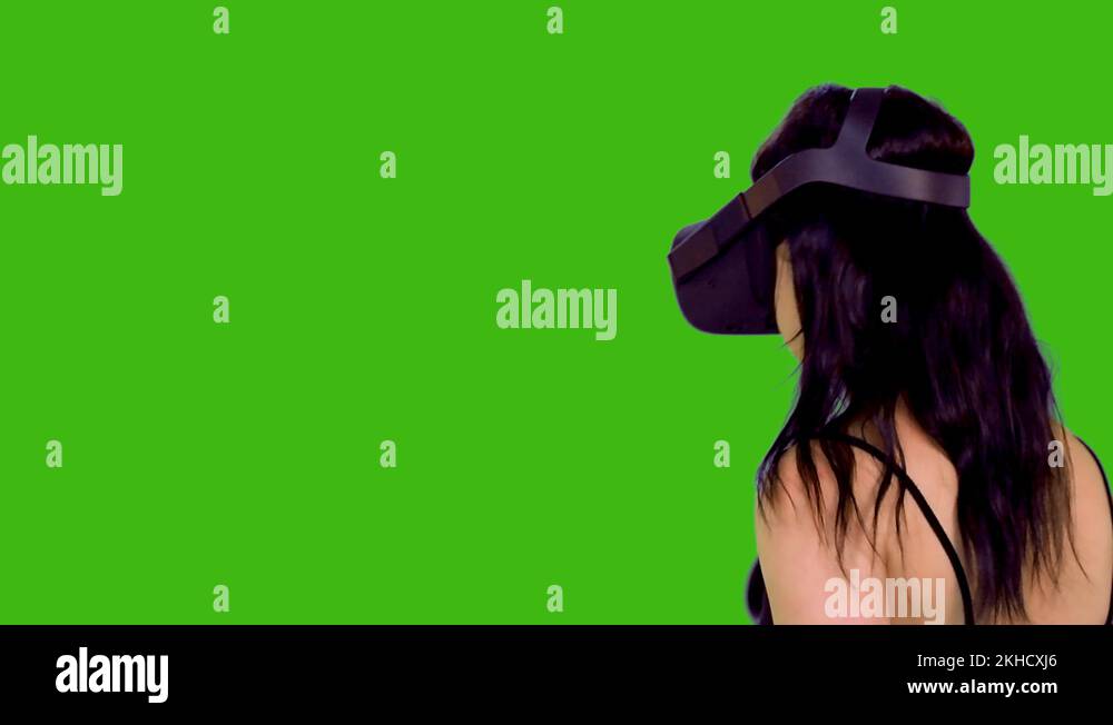 Slow motion playing VR by a teenage girl over green screen Stock Video ...