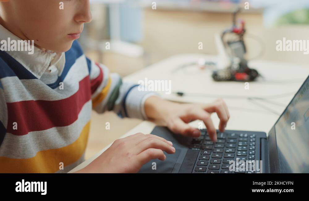 Smart Schoolboy Uses Laptop to Program Software for Robotics ...