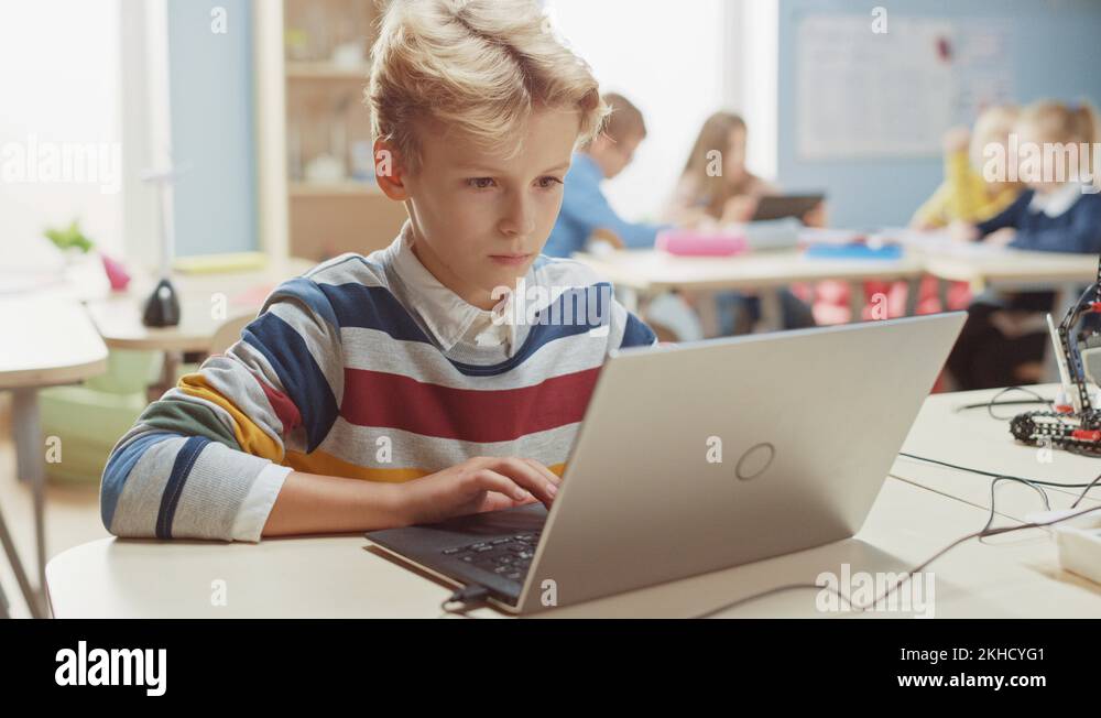 Smart Schoolboy Uses Laptop to Program Software for Robotics ...