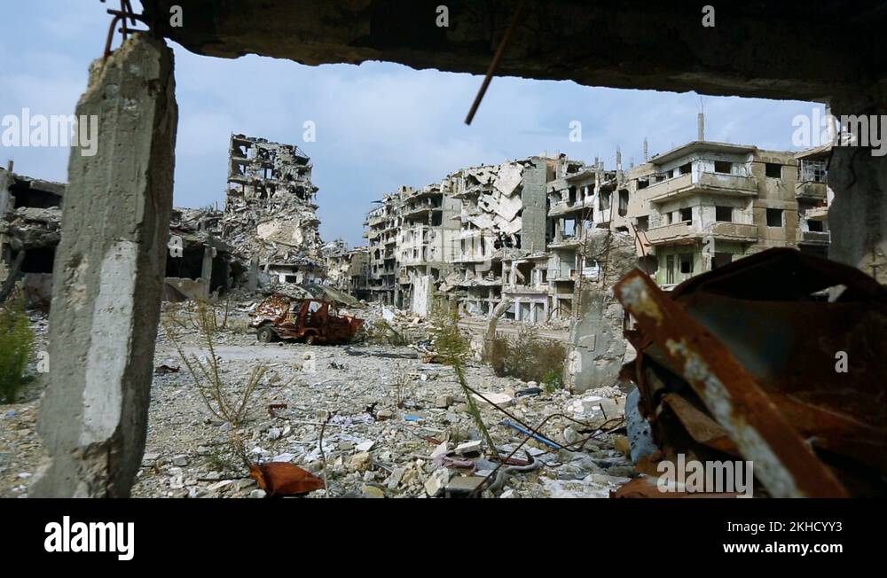 Slide camera in front of ruins of devastated neighborhoods in Homs ...