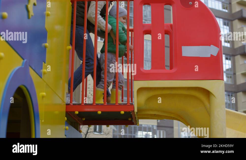 Young Boy Enjoying Playground Slide with Mom and Dad Stock Video ...