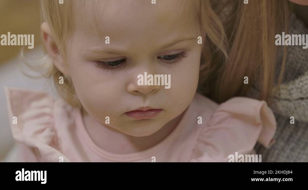 Extreme close-up of sad little Caucasian girl looking down. Portrait of cute Stock Video Footage ...