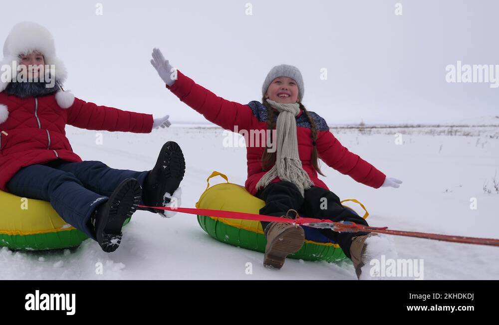 children sledding in winter. teenagers play on christmas vacation in ...