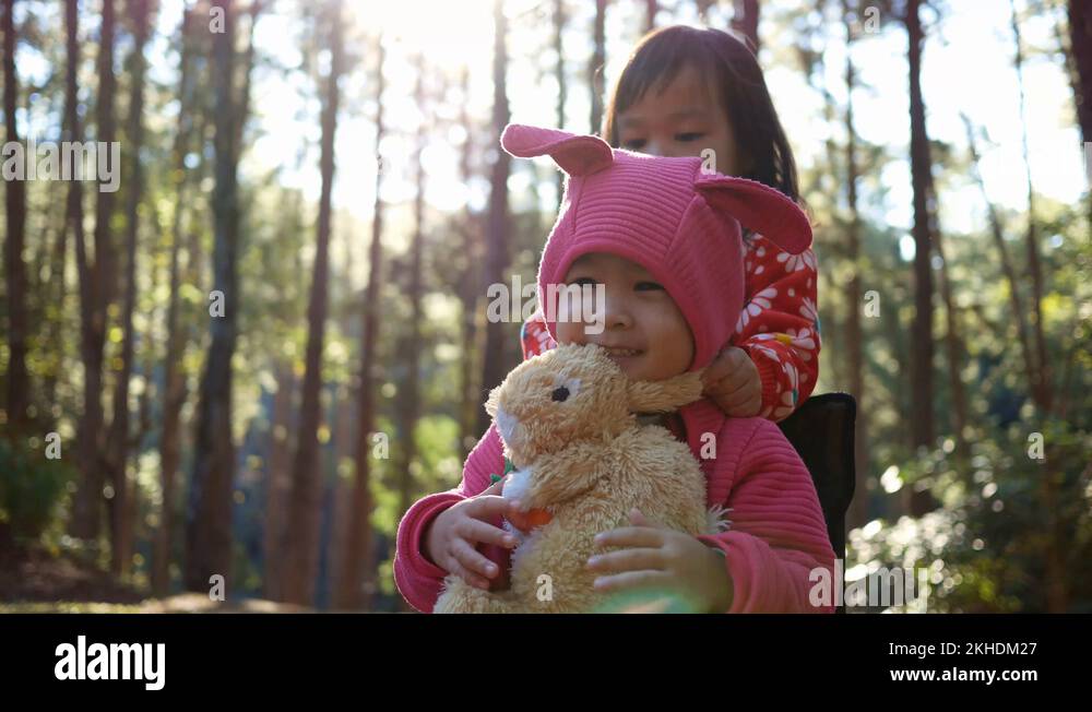 Child girl sitting on chair and play with sister while going camp with ...
